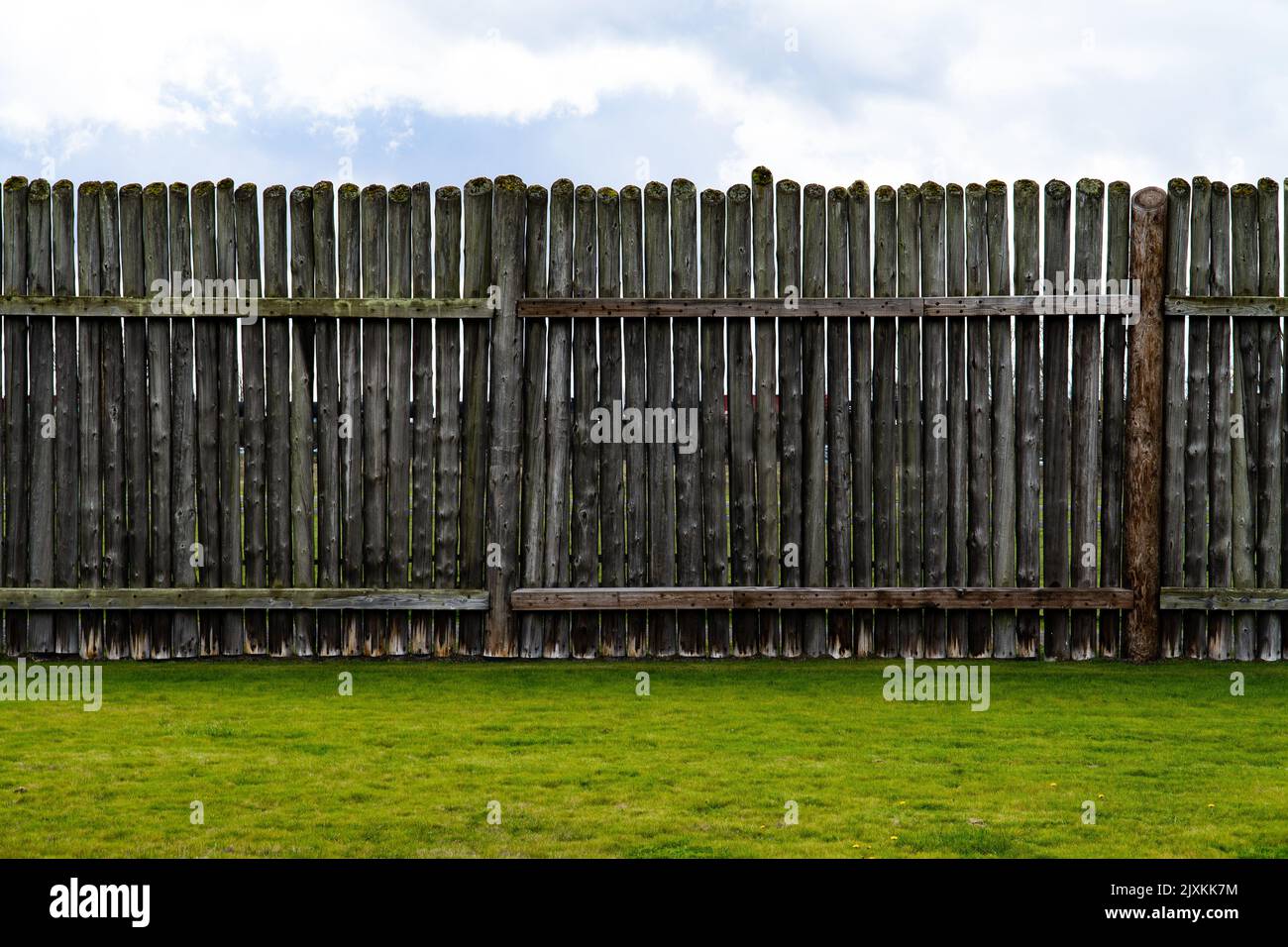 A wooden fence in a green meadow against the clouds Stock Photo - Alamy