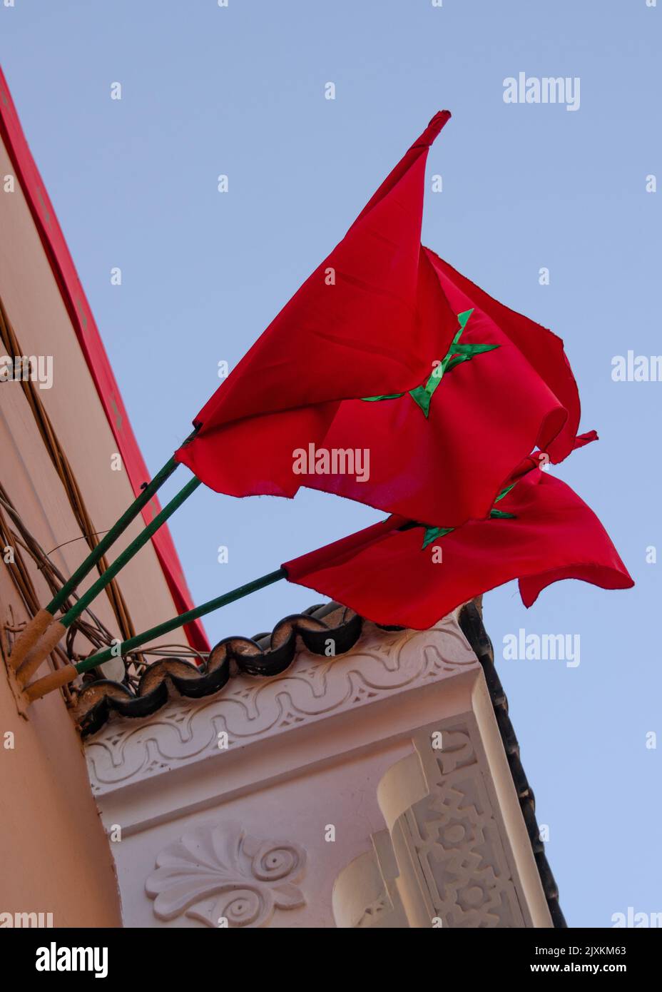 Moroccan flags waving outside a Marrakesh building Stock Photo - Alamy