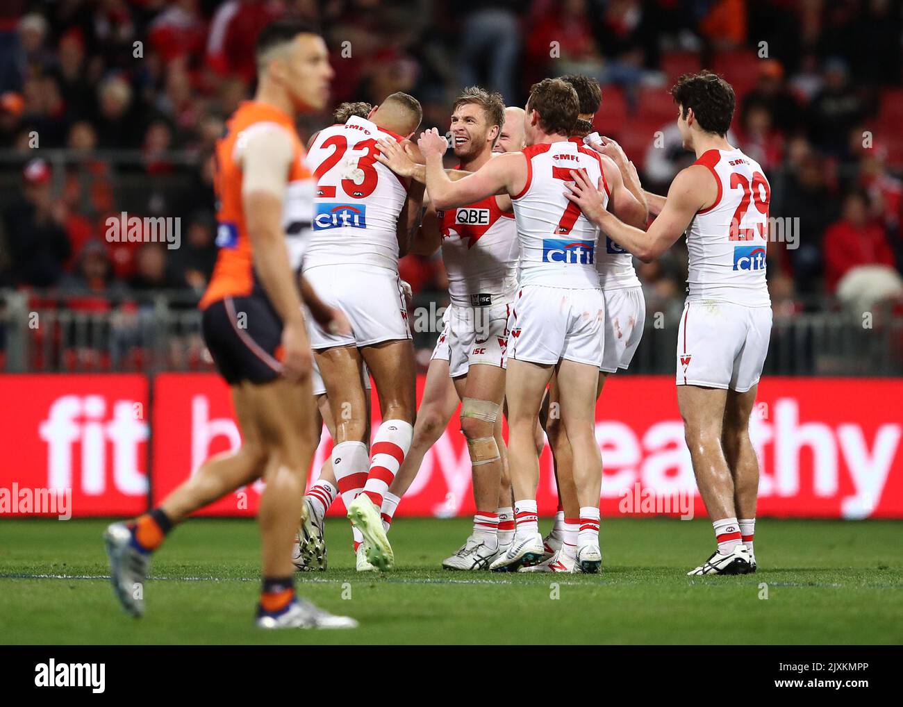 Luke Parker of the Swans celebrates kicking a goal with teammates ...