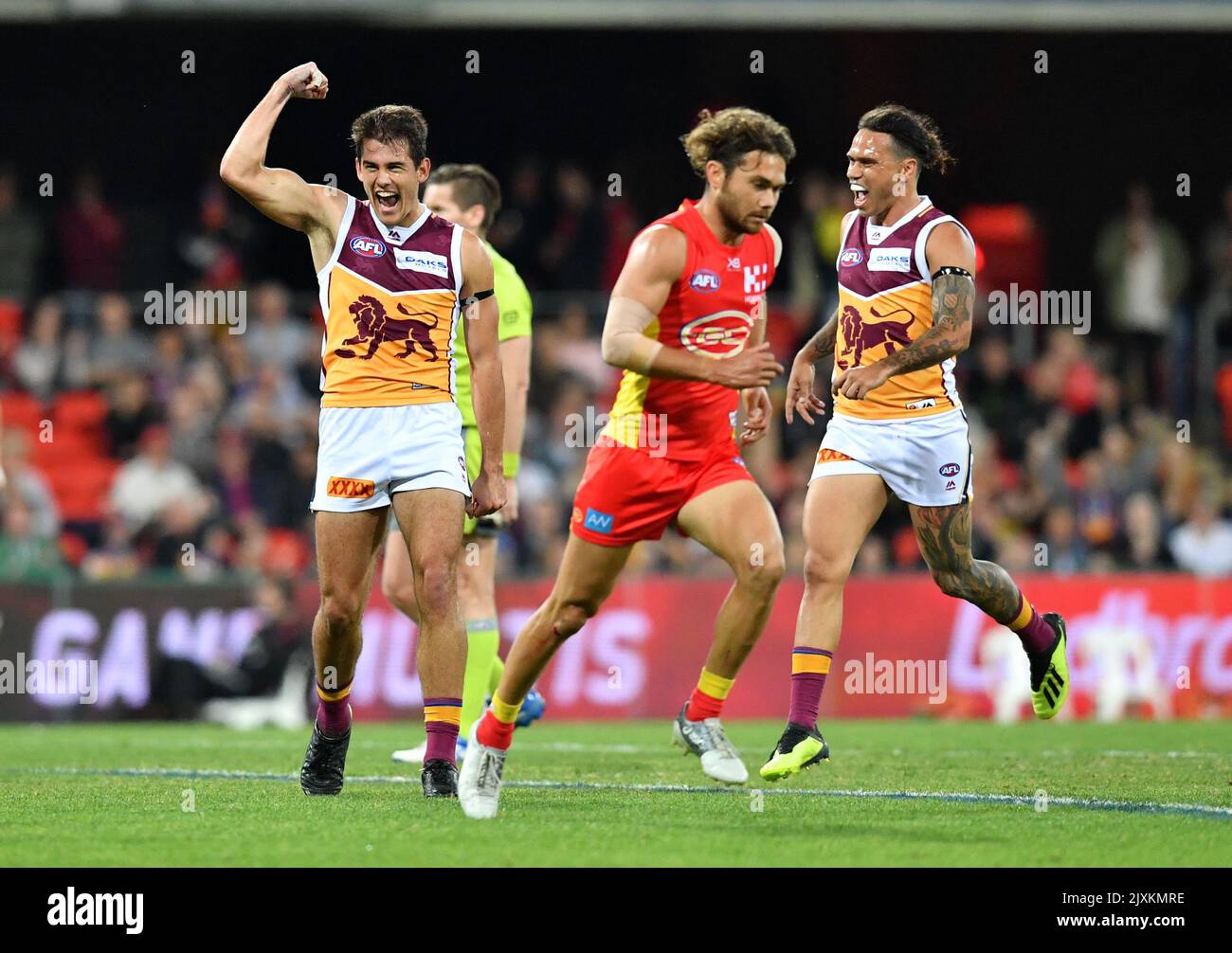 Brandon Starcevich (left) of the Lions celebrates kicking his first AFL ...
