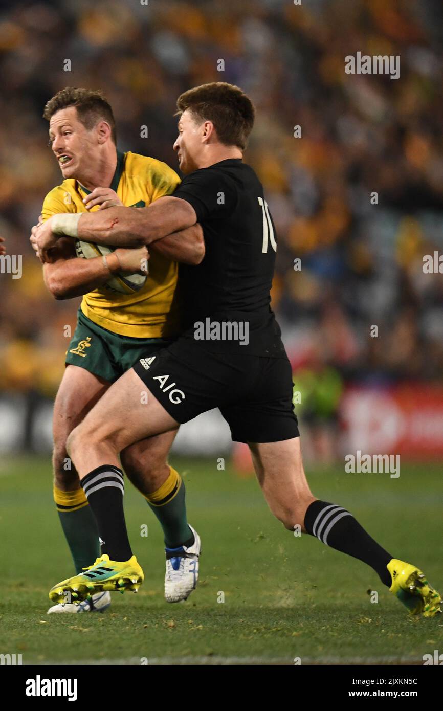 Bernard Foley of the Wallabies tries to push through a tackle by ...