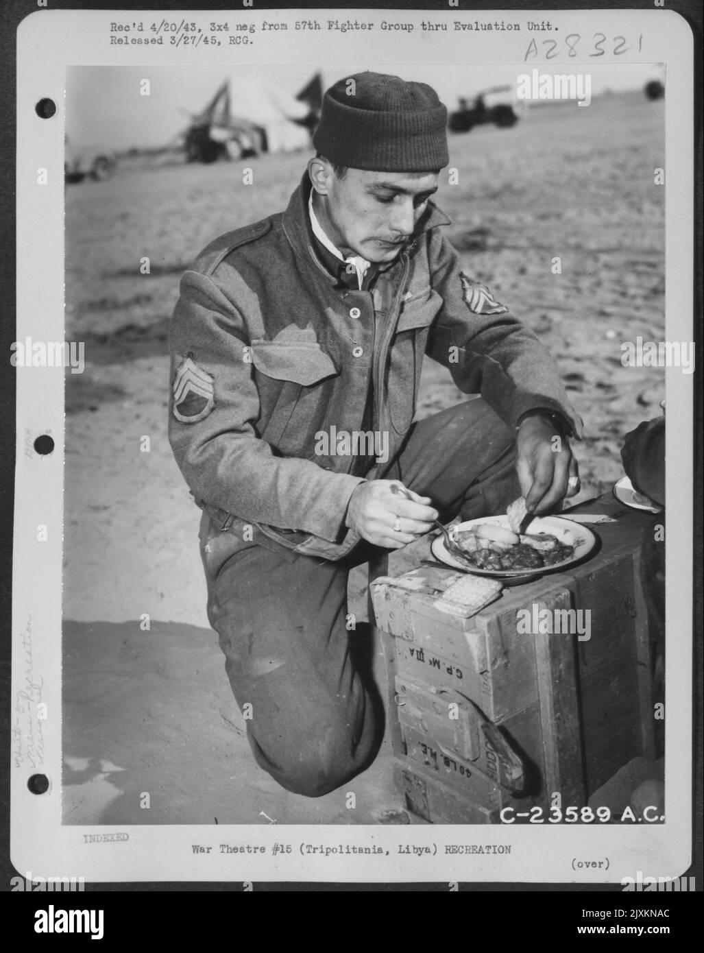 Using a box for a table, S/Sgt. Baker took time out for lunch when the ...