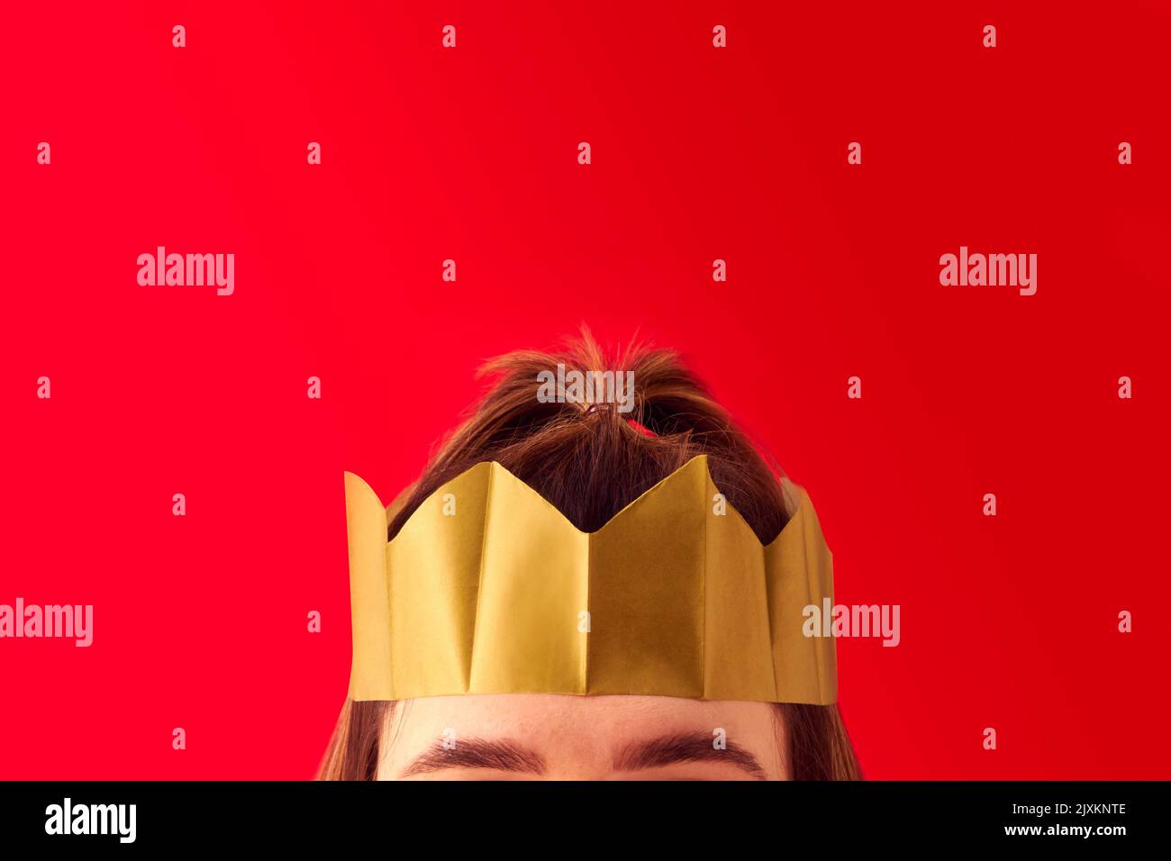 Close Up Studio Shot Of Woman Wearing Christmas Paper Crown Hat Against ...
