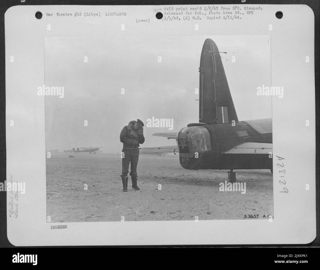 A pilot leans against the wind as he makes his way to a shelter during ...