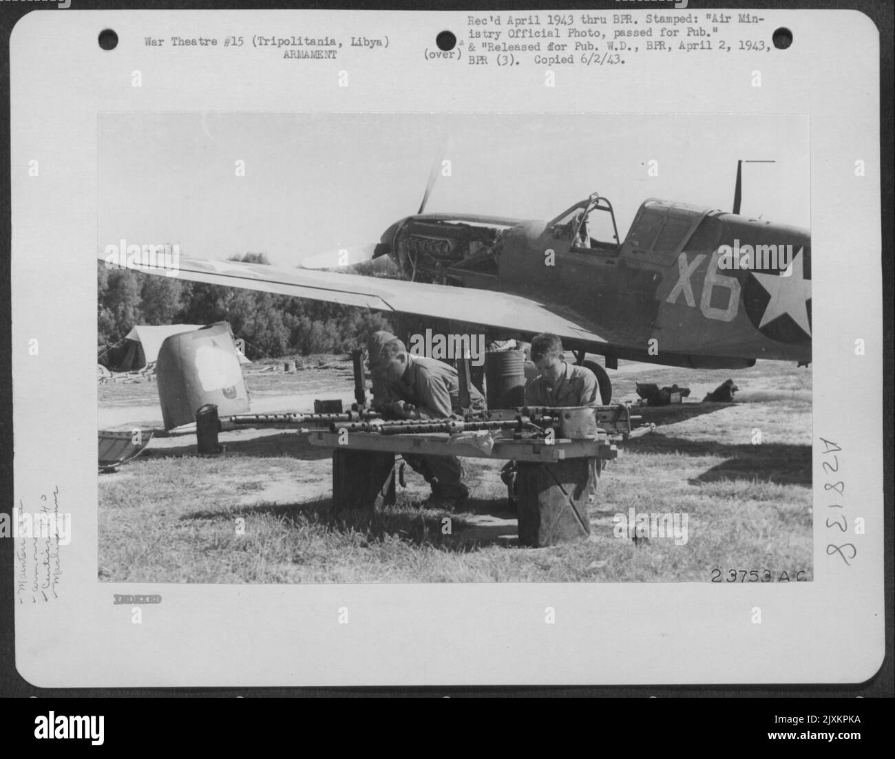 Armourers of the United Army Air Forces at work on the guns of a ...