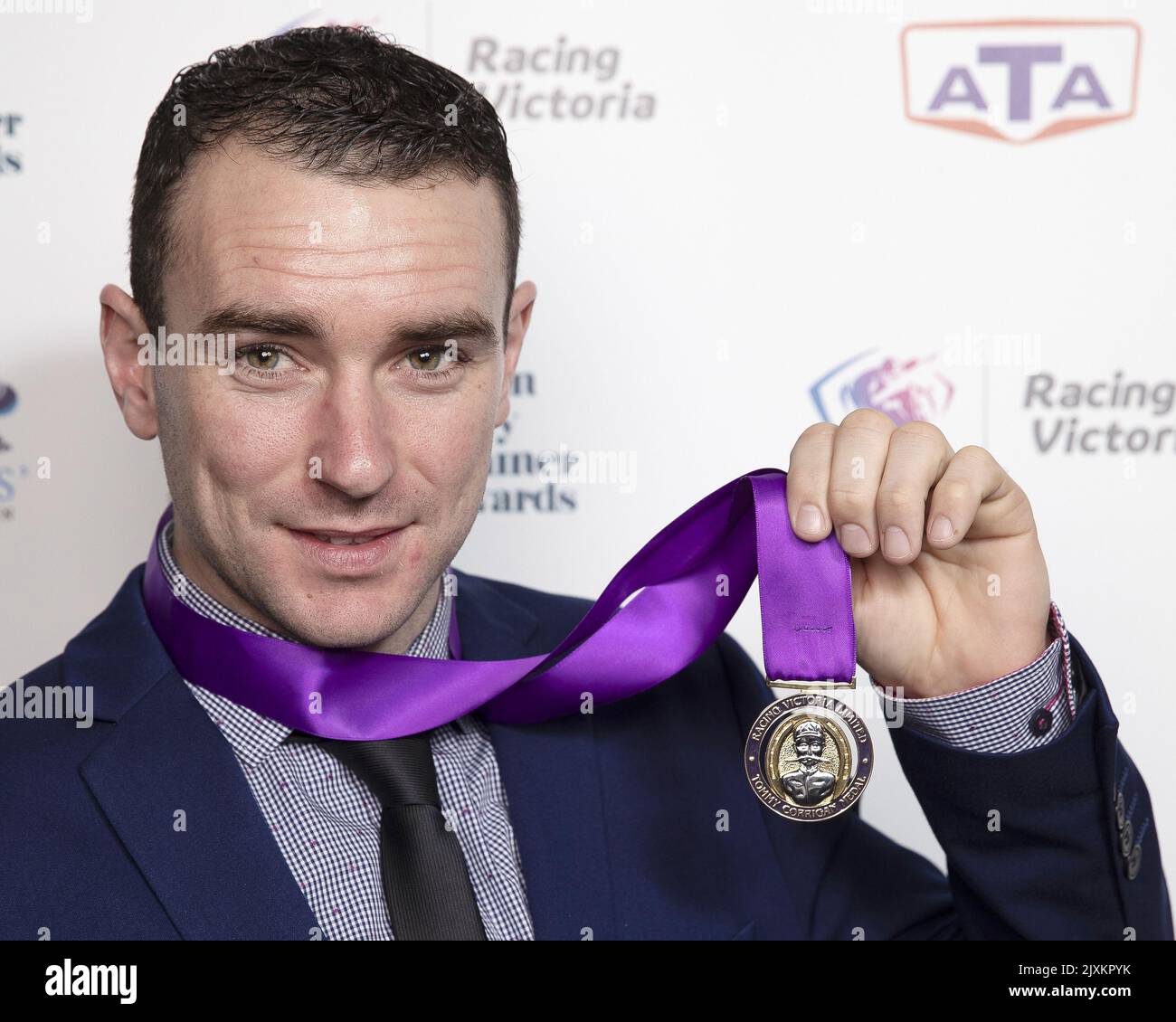 Martin Kelly poses for a photograph with the Tommy Corrigan Medal ...
