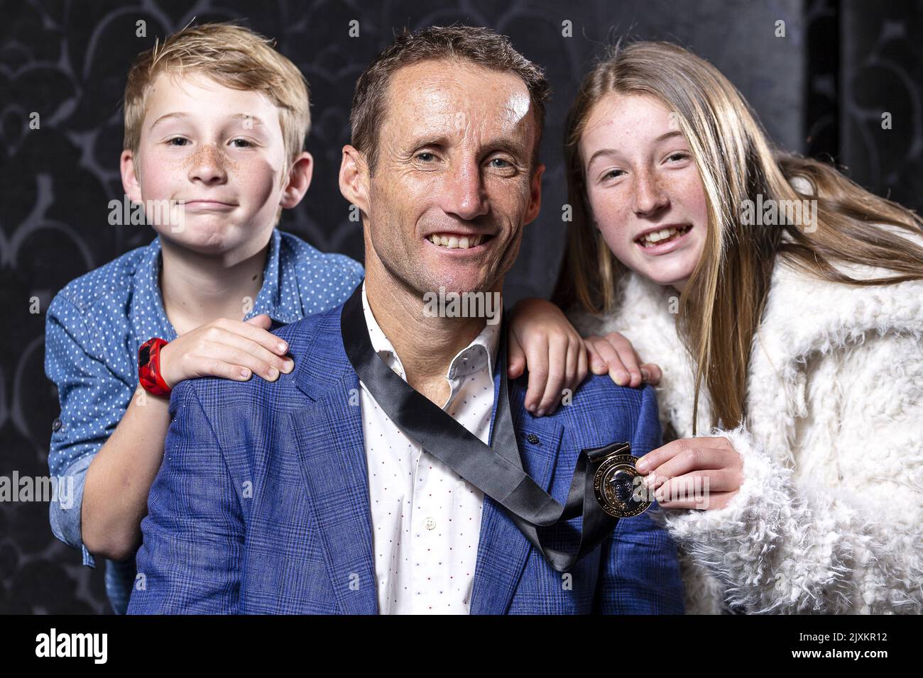 Damien Oliver poses for a photograph with his son Luke and daughter ...