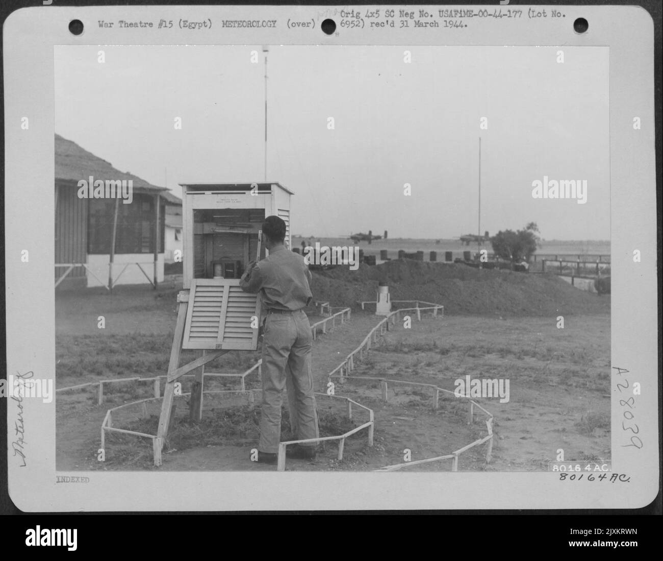 A GI uses a slide rule to condense results of barometer readings and ...