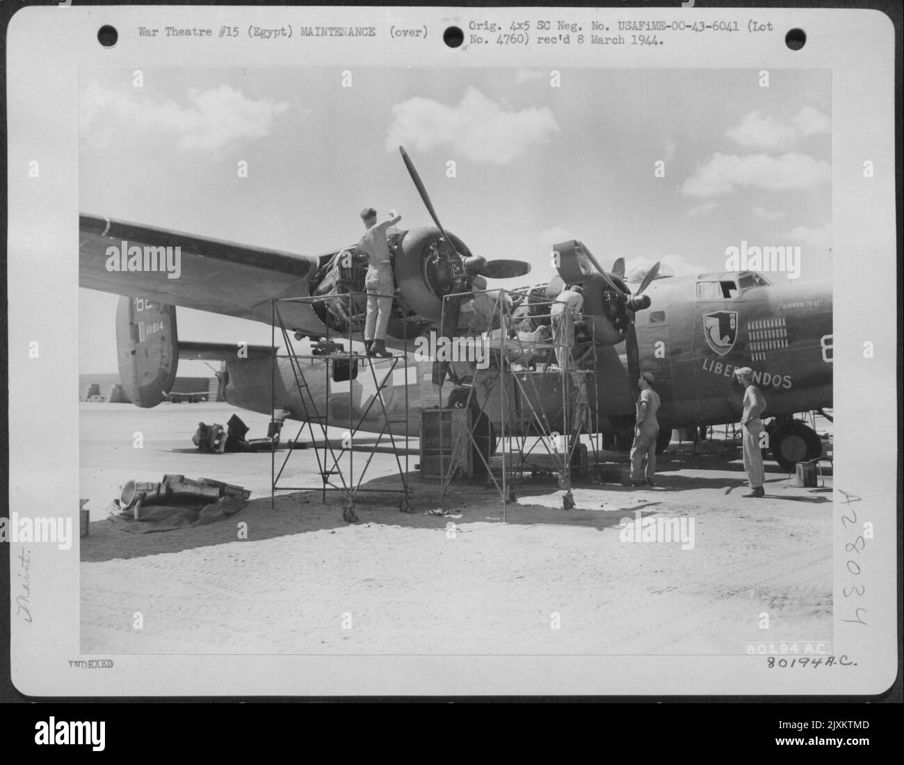 Crew working on a Consolidated B-24 preparatory to take-off from an ...
