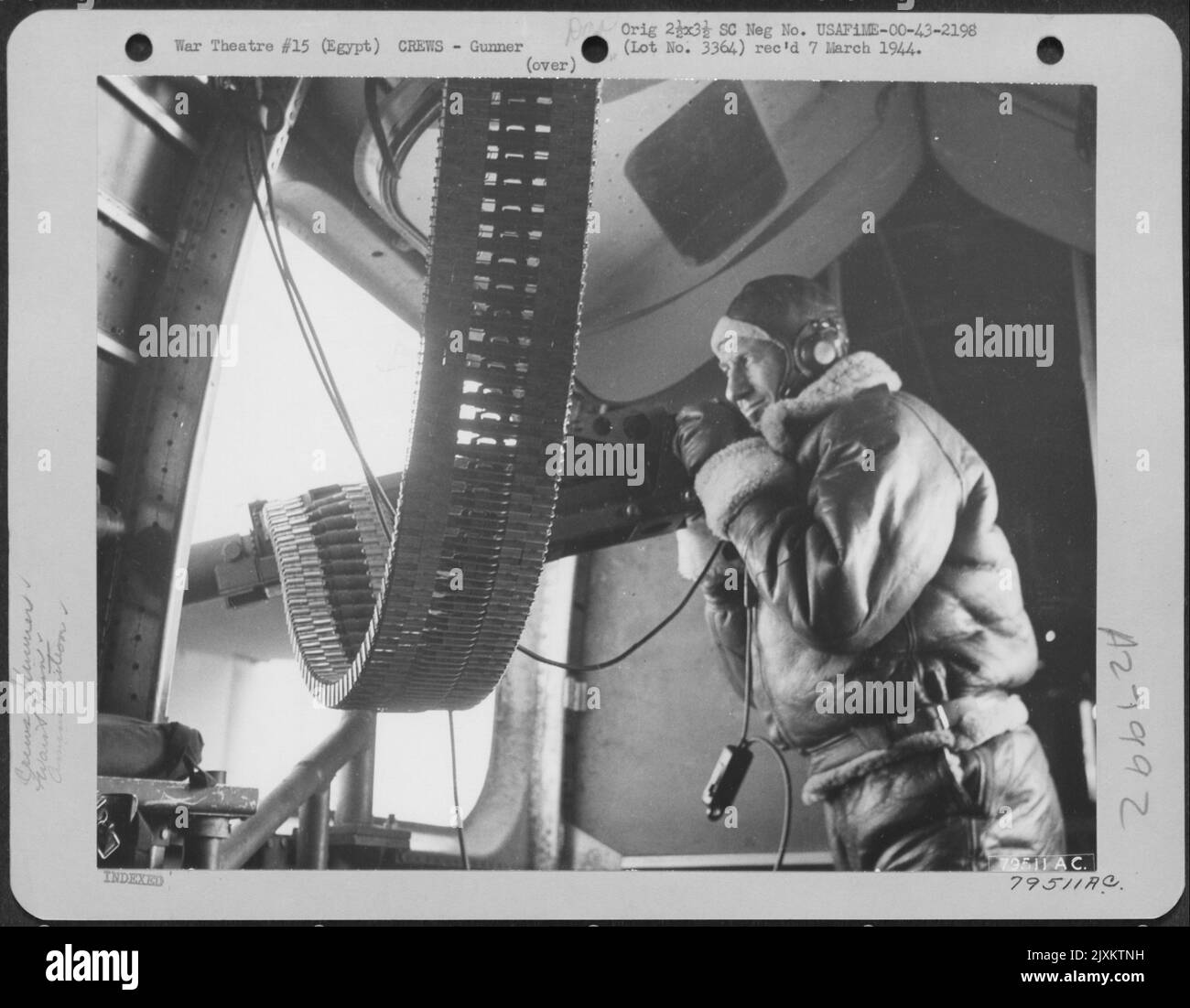A waist gunner is shown at his position on a Consolidated B-24 ...