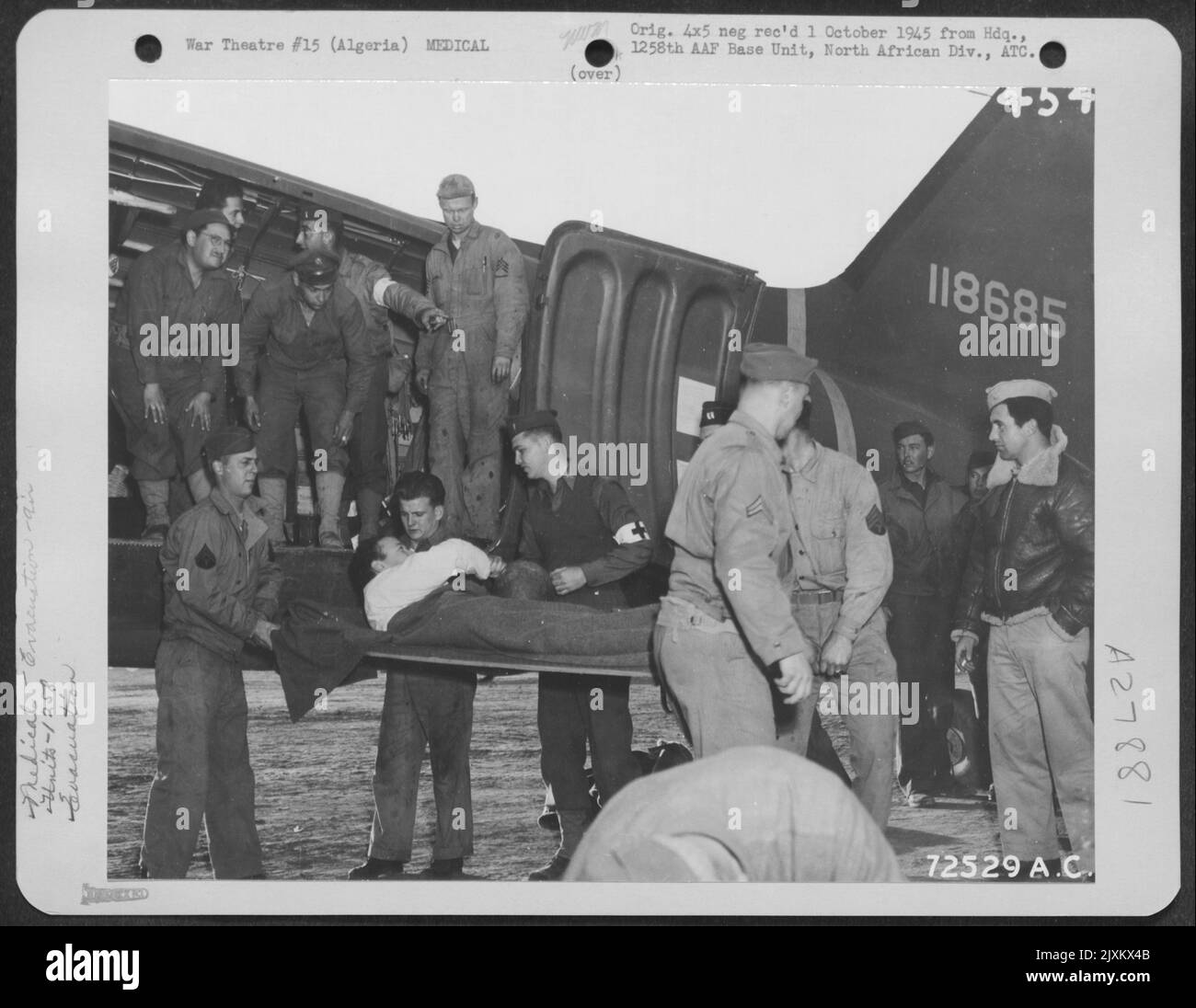 A wounded airman is taken off a hospital plane at La Senia Airfield in ...