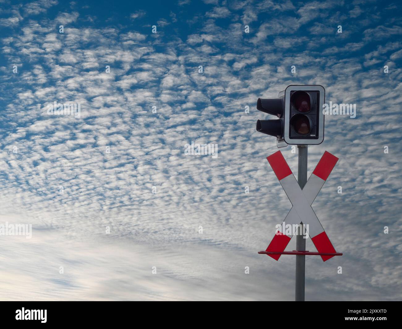 A led traffic light over a road sign agains a scenic cloudy sky Stock ...
