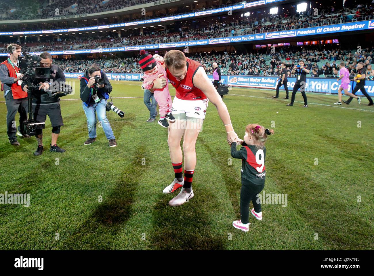 Brendon Goddard of the Bombers runs out with his kids ahead of the ...