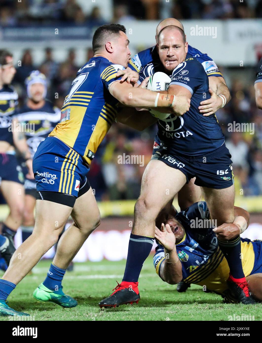 Matthew Scott, co-captain of the Cowboys, is tackled by Eels defence ...