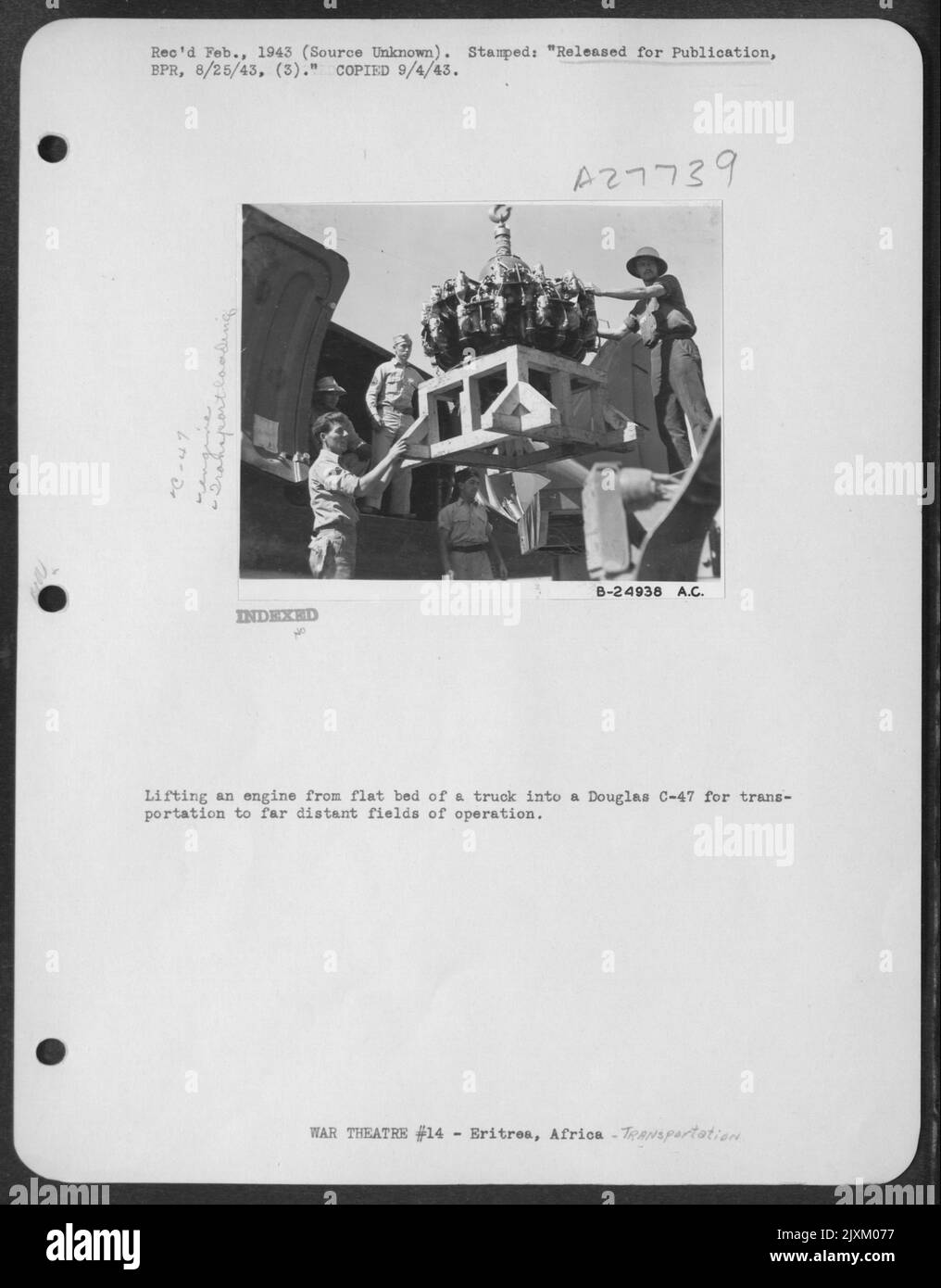 Lifting an engine from flat bed of a truck into a Douglas C-47 for ...