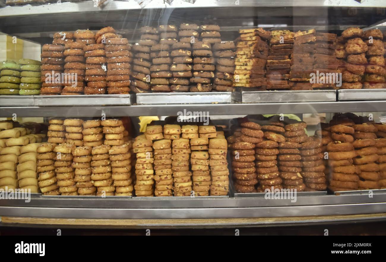 A display of various crunchy cookies and biscuits arranged inside a ...