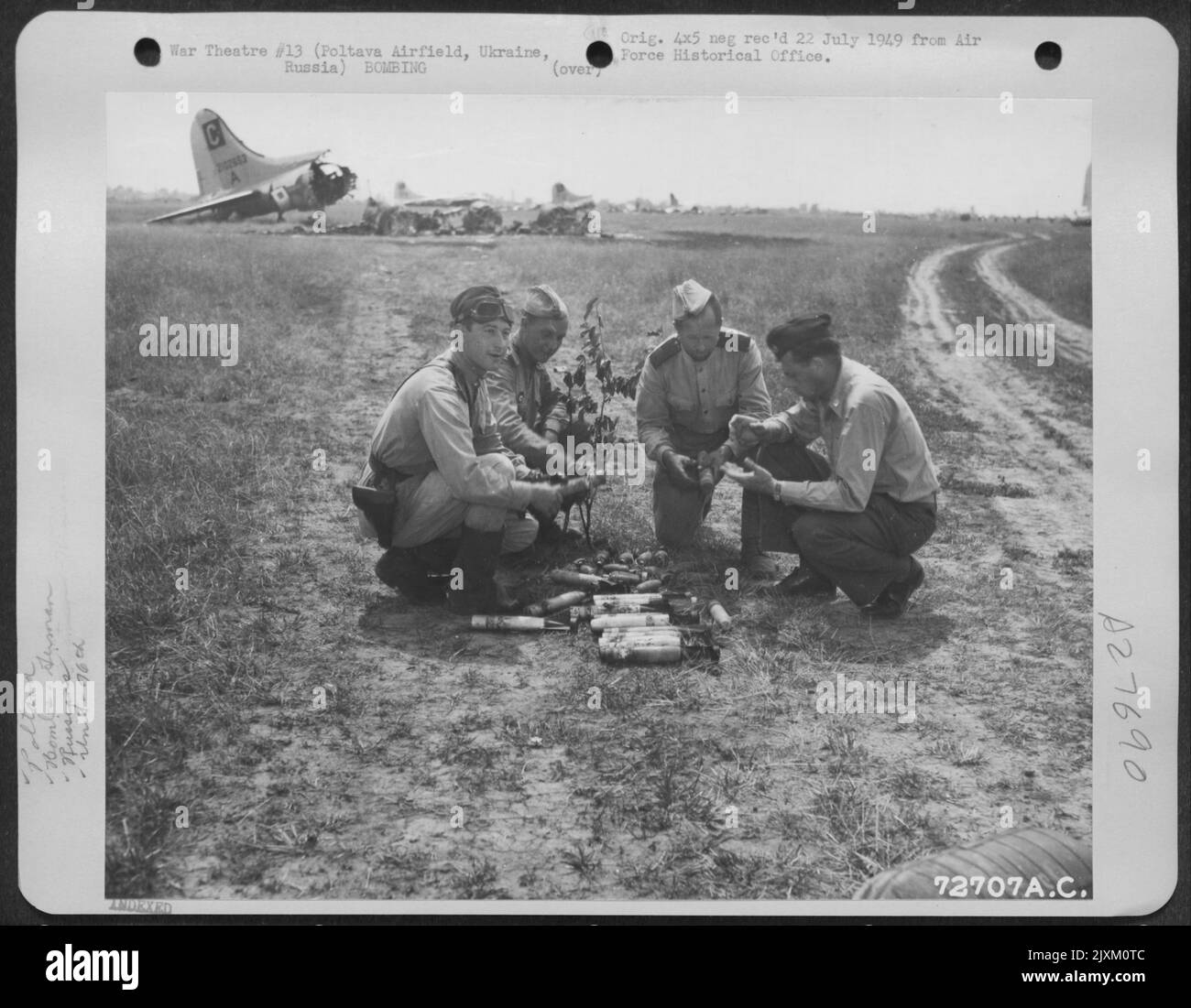 A USAF Officer and Russian soldiers inspect German bombs shortly after ...