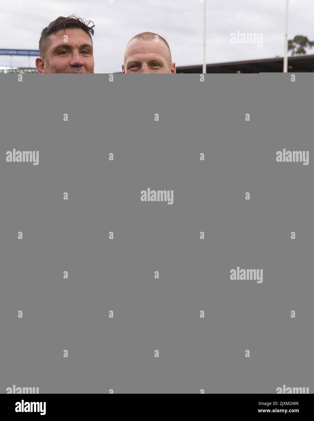 Chris Heighington of the Knights and Luke Lewis of the Sharks hug after ...