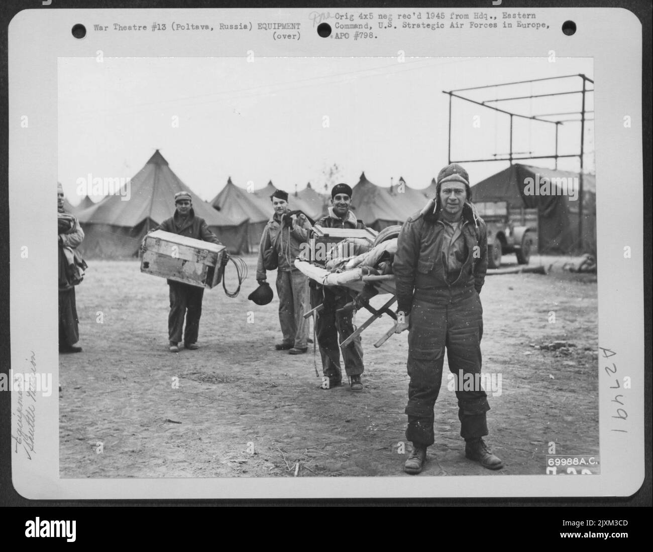 American GIs move their things from tents (background) to the newly ...