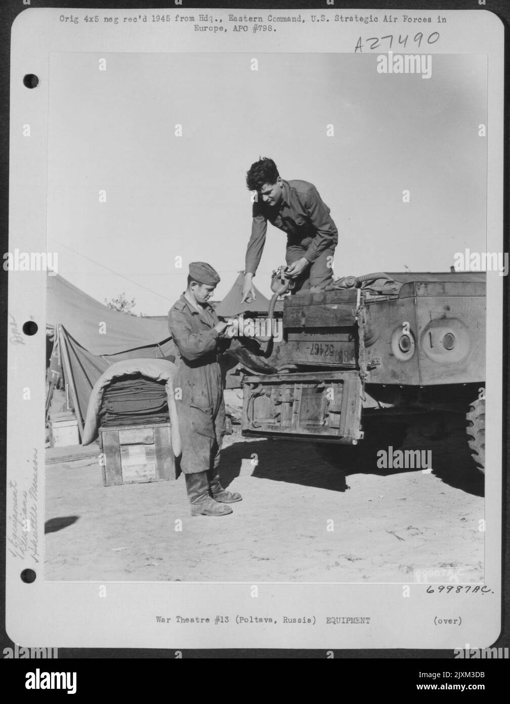 An American GI explains the fundamental points of a gas mask to a ...