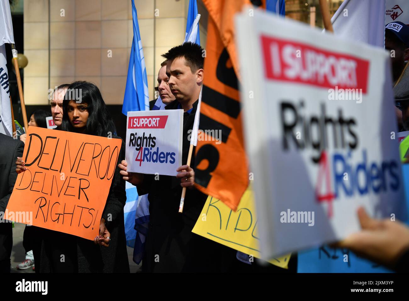 Protestors hold placards during a delivery drivers rally ahead of a ...