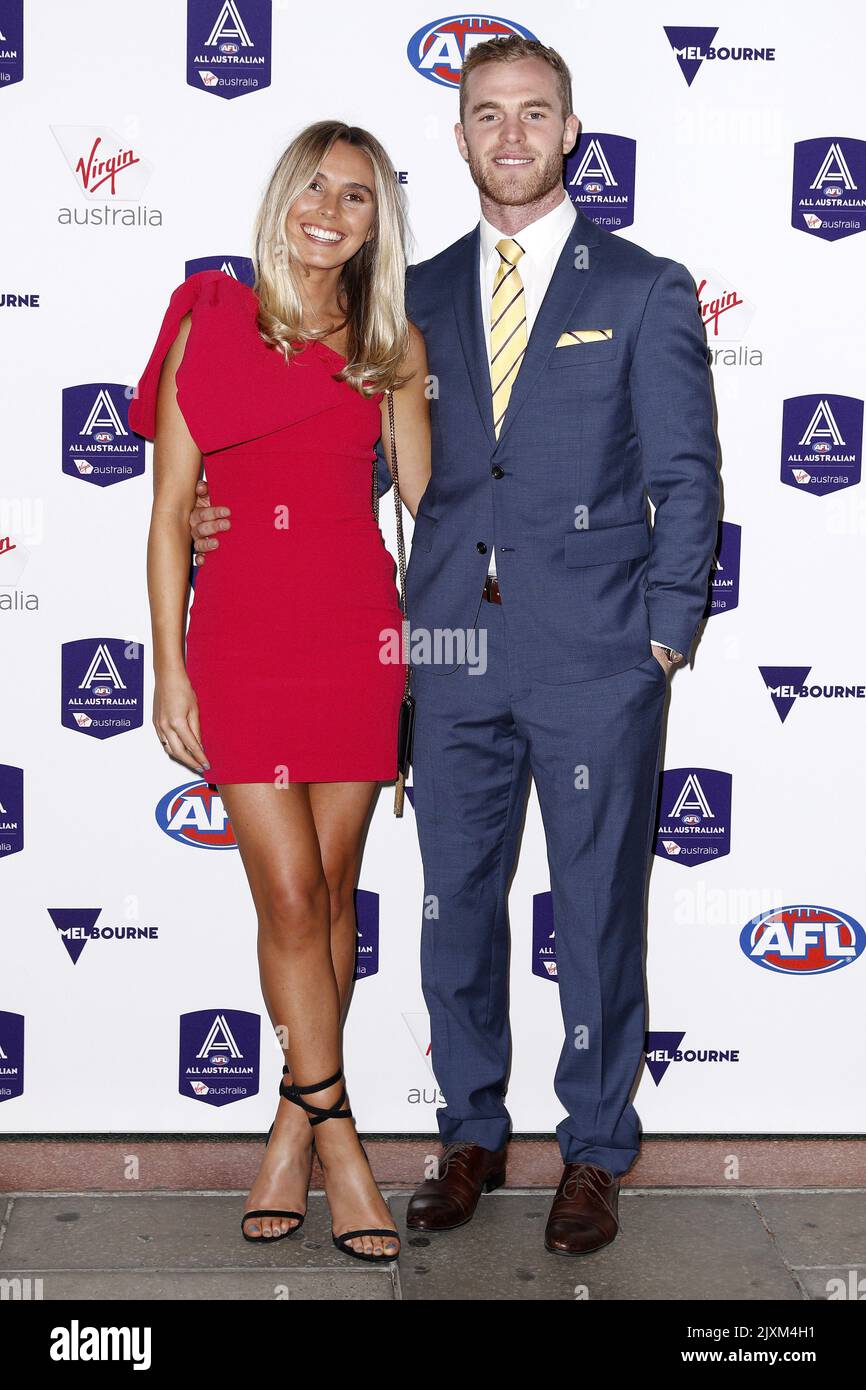 Tom Mitchell of the Hawks and partner Hannah Davis arrive ahead of the ...