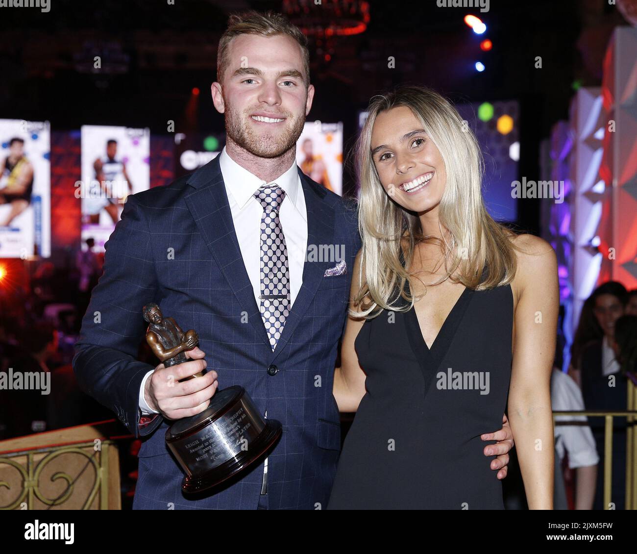 Tom Mitchell of the Hawks and partner Hannah Davis pose for a photo ...