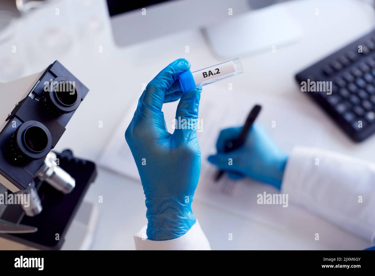 Close Up Of Female Lab Worker Wearing PPE Researching BA.2 Variant Of ...