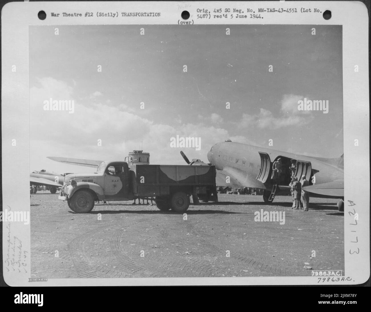 A Douglas C-47 transport plane is unloaded at Cassibile, Sicily. 2 ...