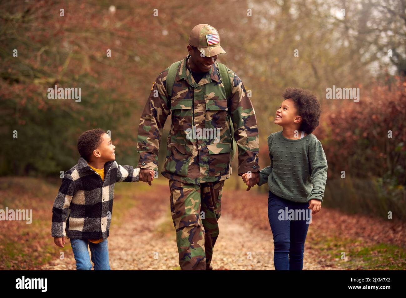American Soldier In Uniform Returning Home On Leave To Family Holding ...