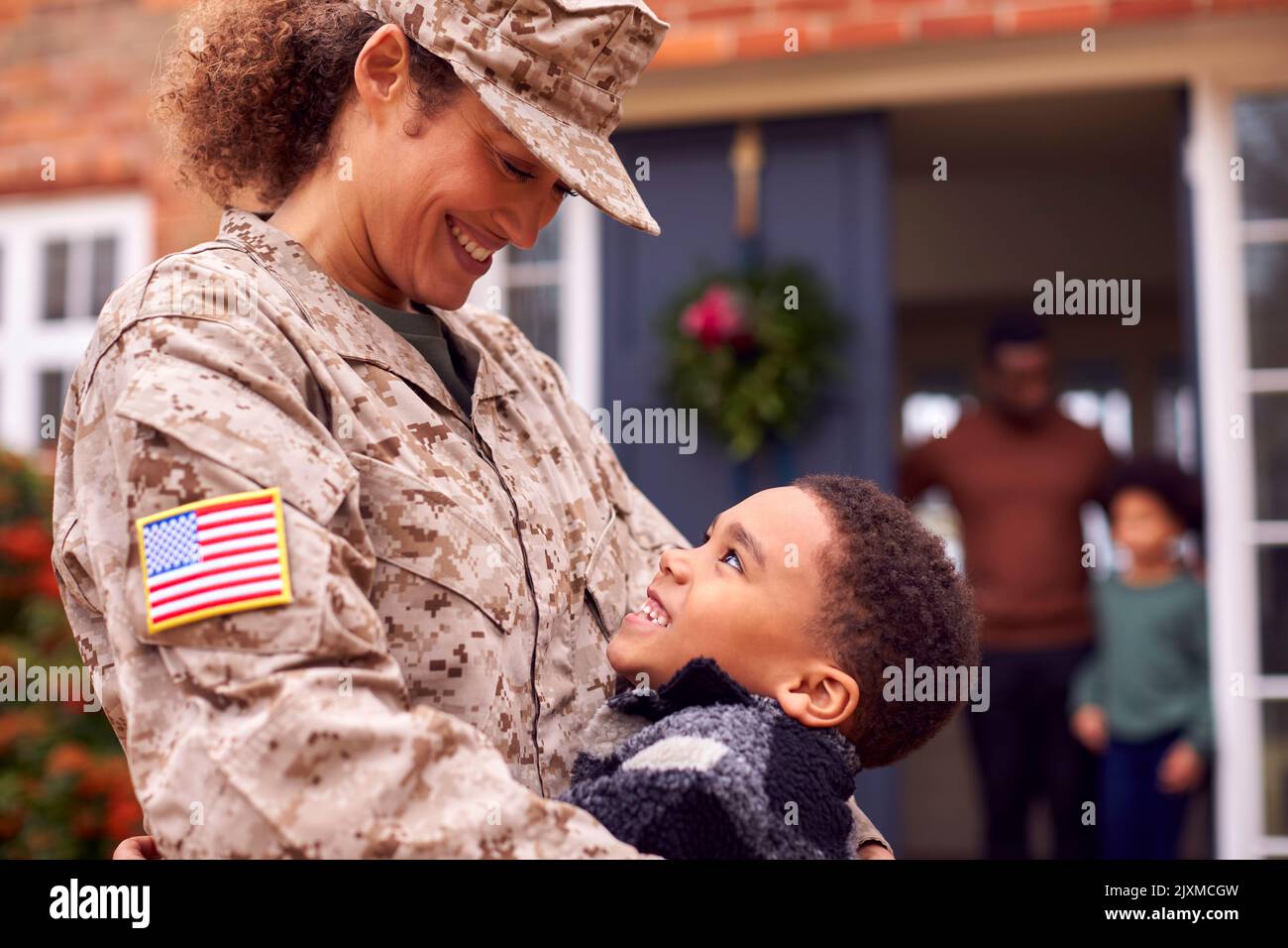 American Female Soldier In Uniform Returning Home To Family On Hugging ...