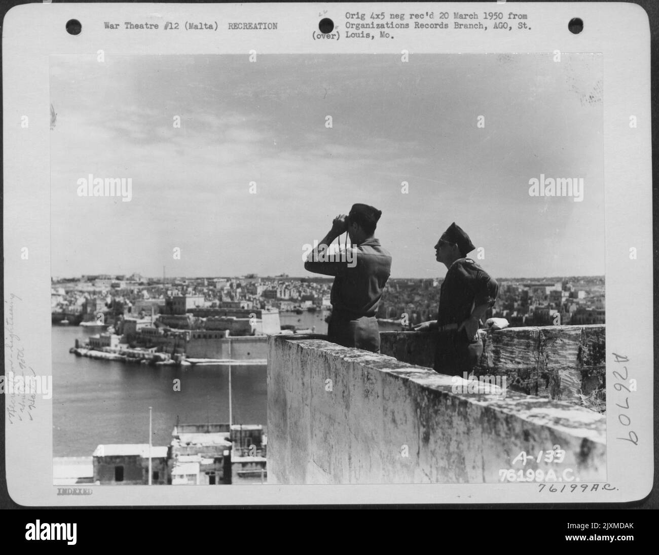 Two members of the 90th Photographic Reconnaissance Wing stand on a ...
