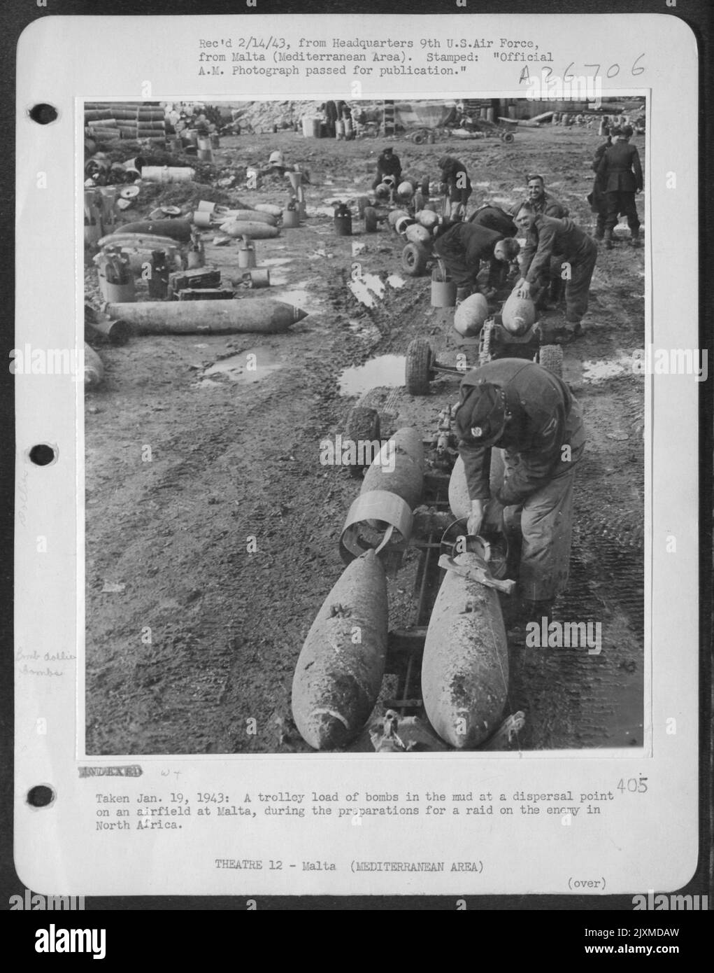 Taken Jan. 19, 1943: A trolley load of bombs in the mud at a dispersal ...