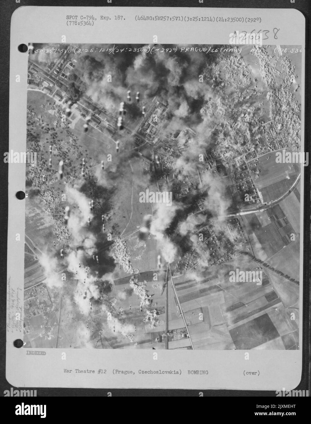 Bombs continue to fall toward the target as others burst on ...