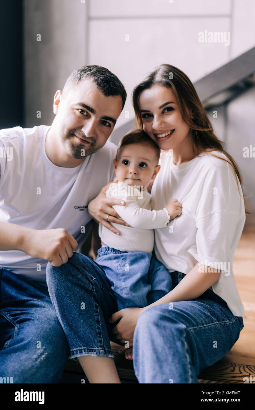 Happy family couple new home owners with kid child son relaxing on ...