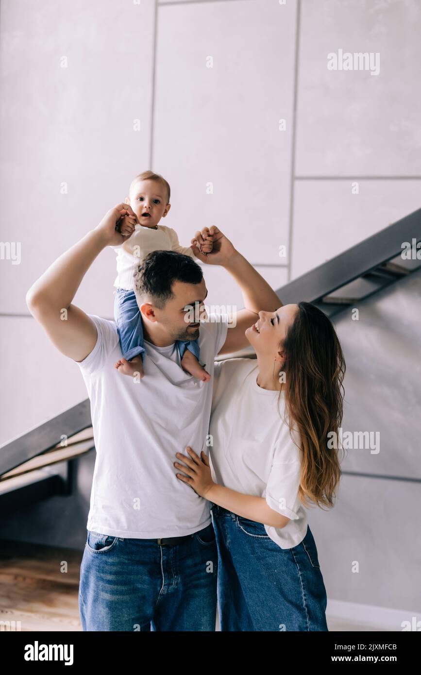 Happy family couple new home owners with kid child son relaxing on ...