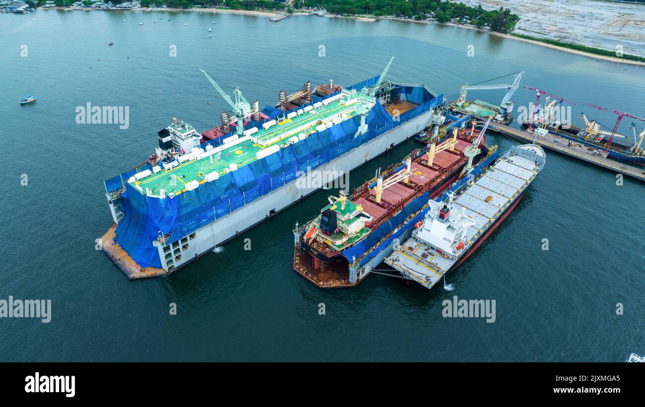 cargo container ship at dry dock concept maintenance service working in ...