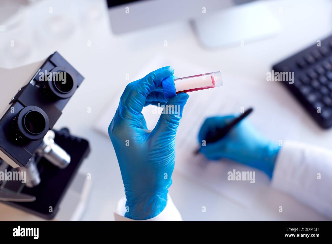 Close Up Of Lab Worker Conducting Research Using Microscope Holding ...
