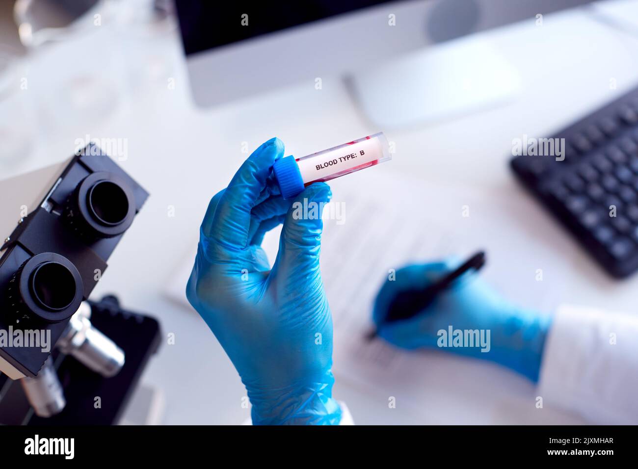 Close Up Of Lab Worker Conducting Research Using Microscope Holding ...