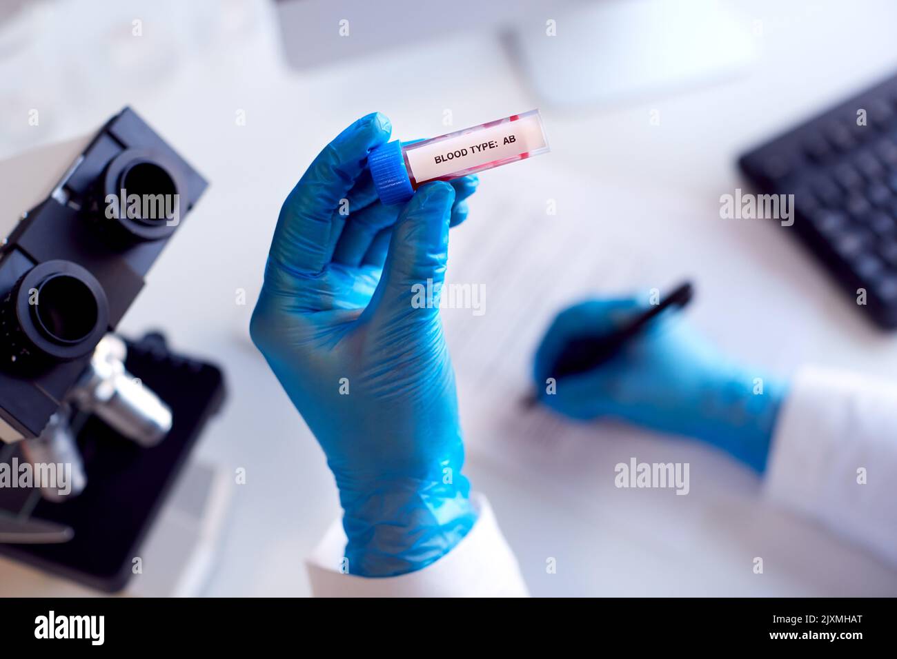 Close Up Of Lab Worker Conducting Research Using Microscope Holding ...
