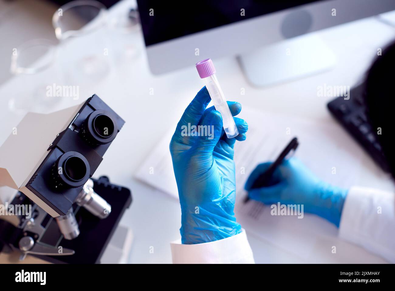 Close Up Of Lab Worker Conducting Research Using Microscope Holding ...