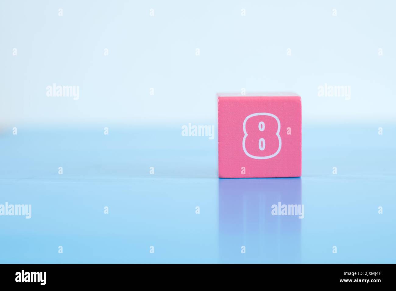 A pink block with number 8 written on the side Stock Photo - Alamy