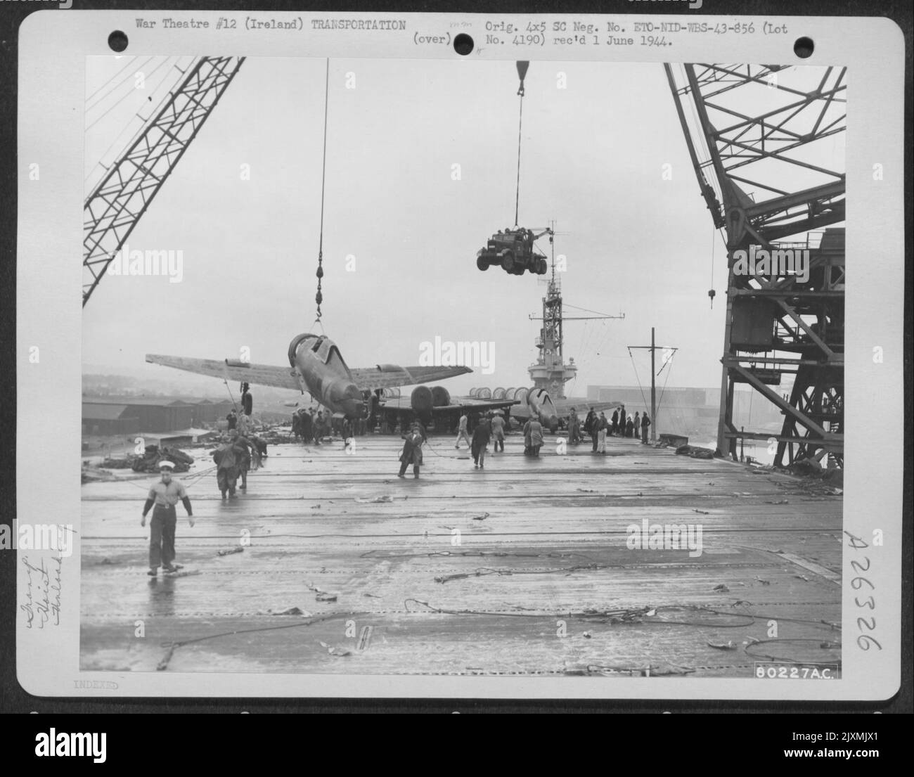A huge floating crane lowers a U.S. Army 5-ton vehicle to the flight ...