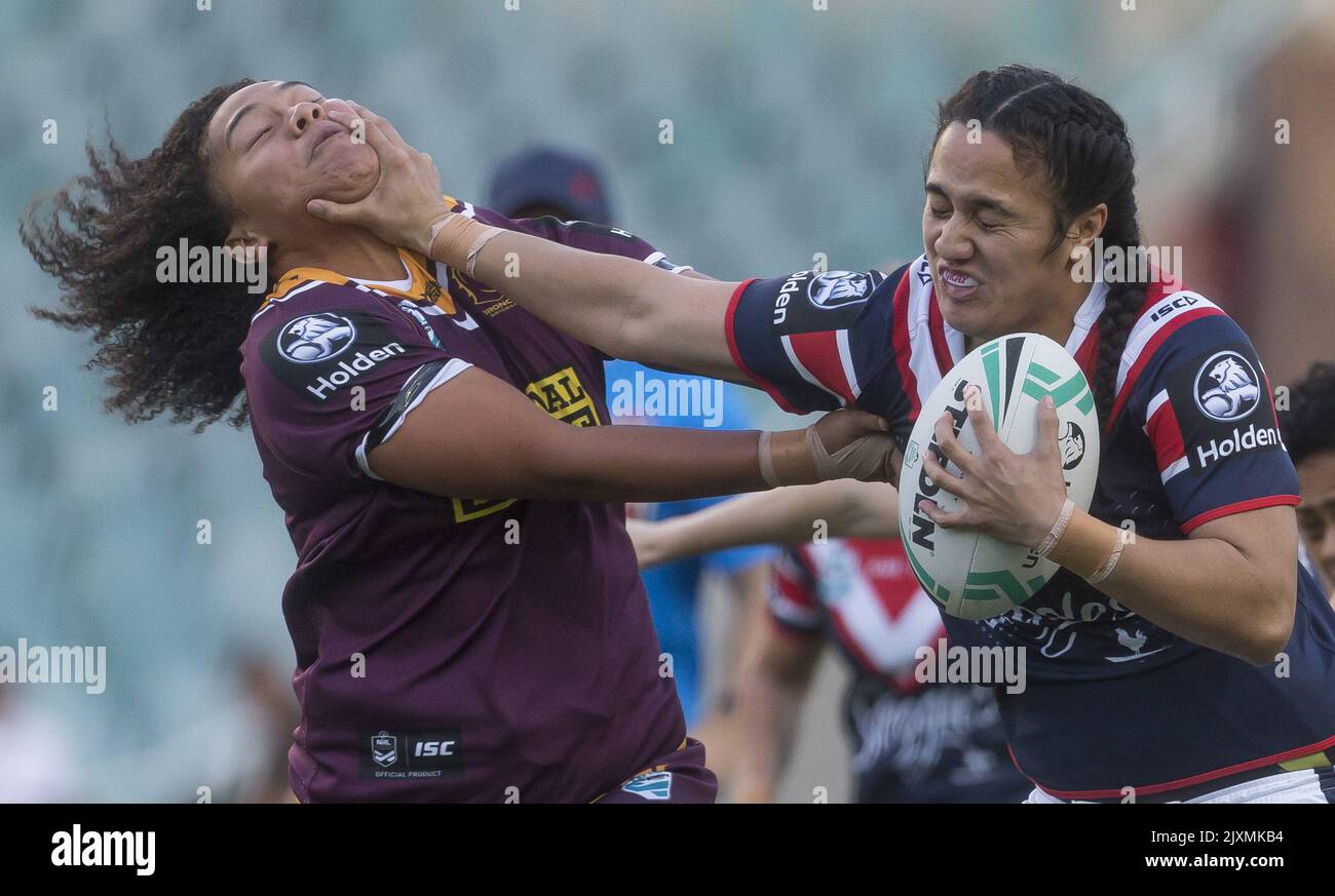 Tazmin Gray of the Roosters fends off a tackle from Teuila Fotu-Moala ...