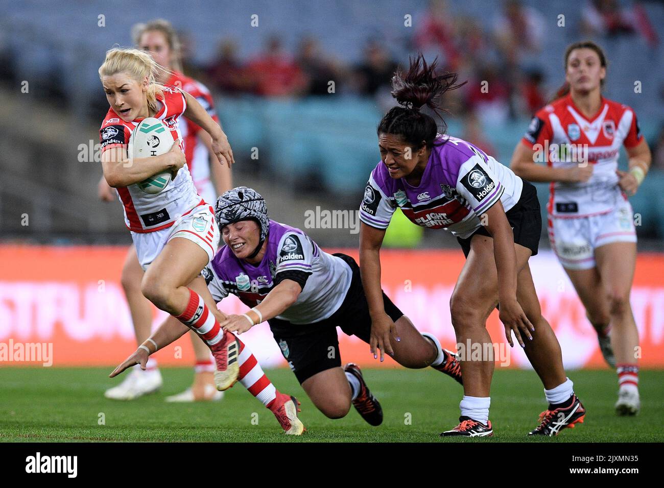 Rikeya Horne of the Dragons evades a tackle by Lorina Papali'i (left ...