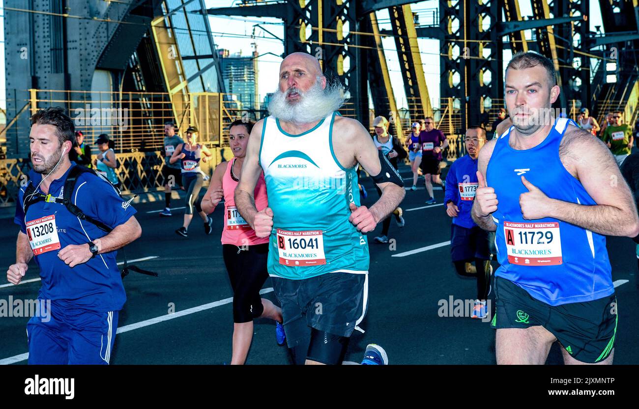 Runners are seen crossing the Sydney Harbour Bridge during the ...