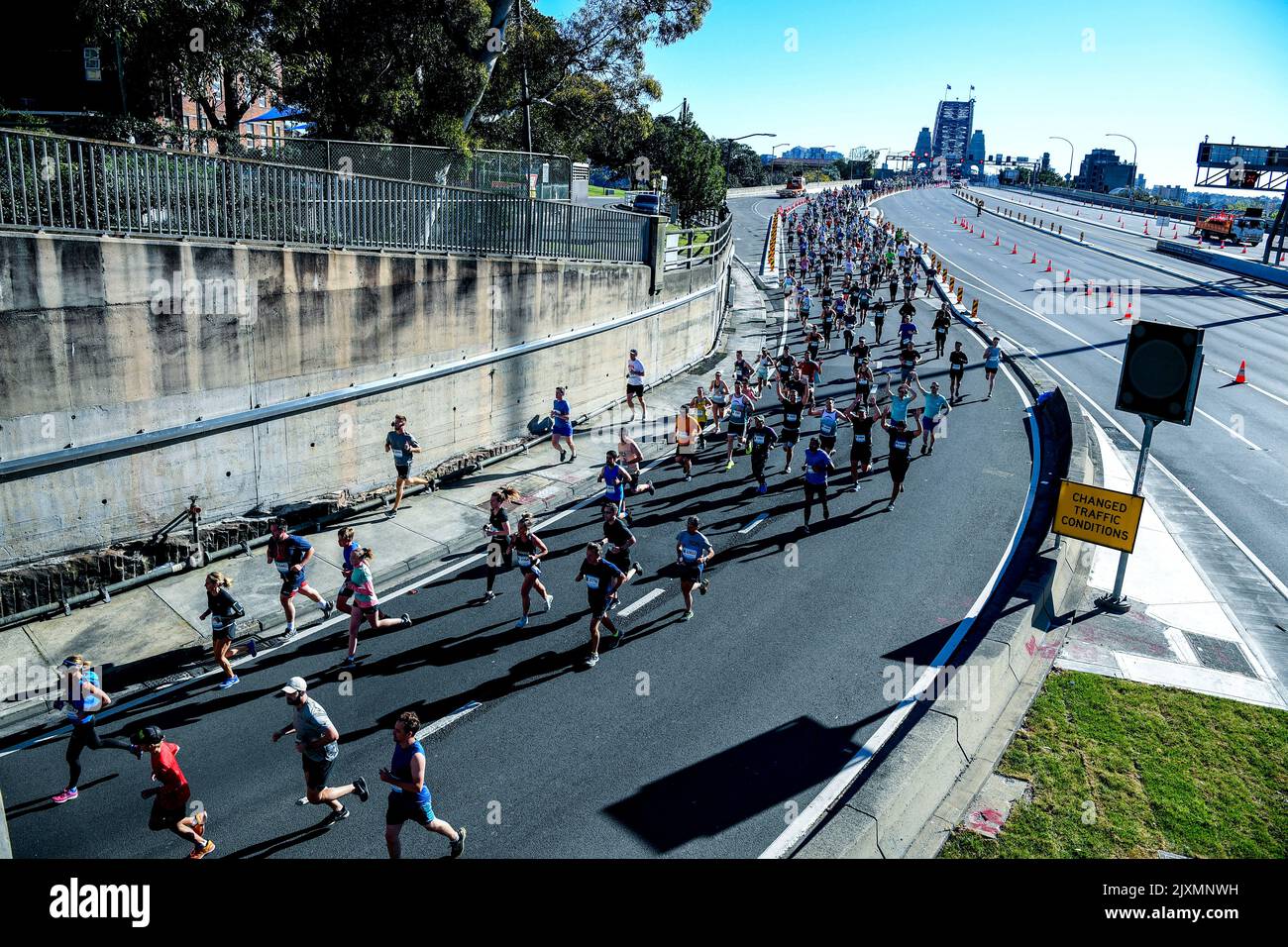 Runners are seen crossing the Sydney Harbour Bridge during the ...