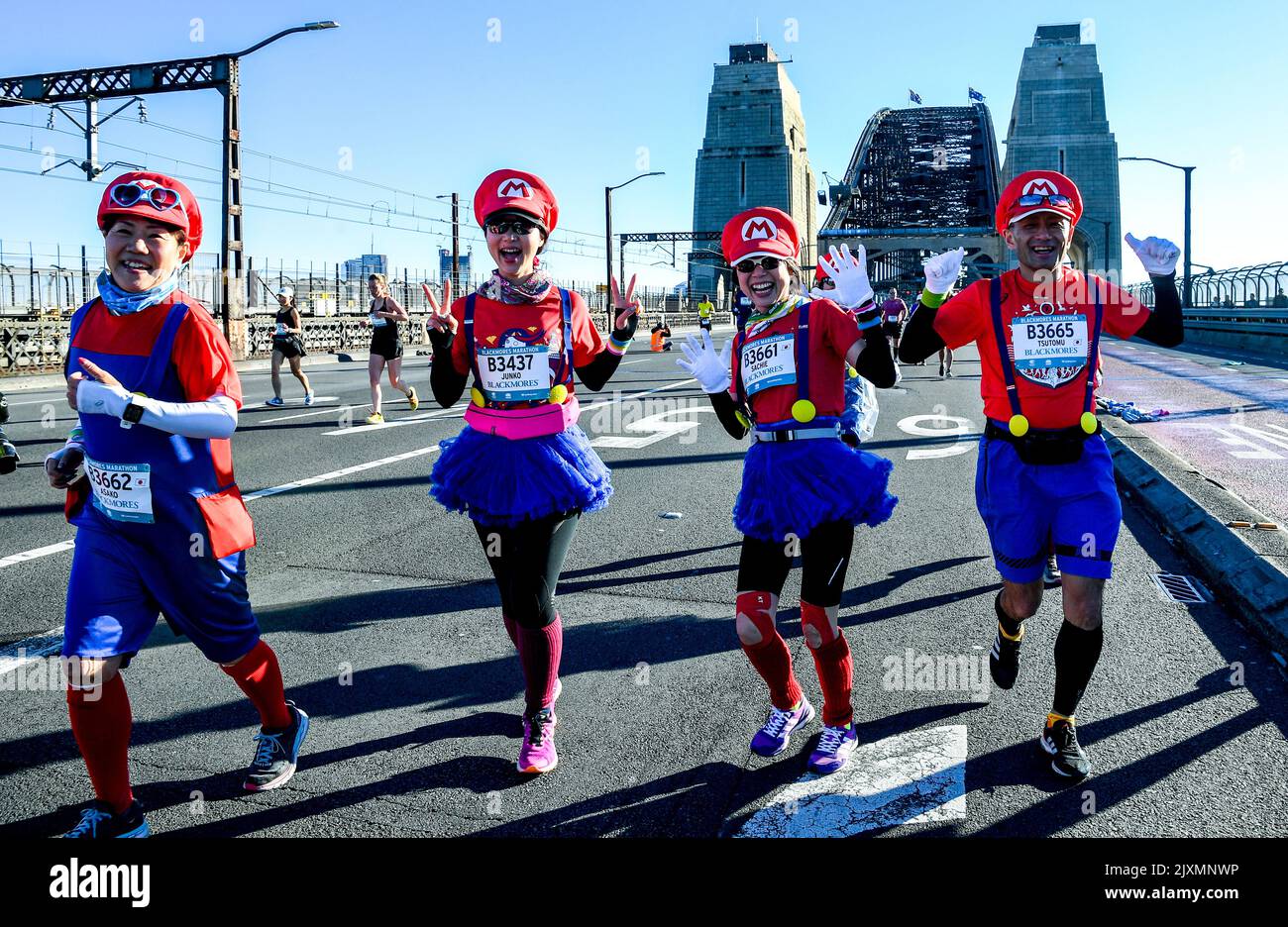 Runners are seen crossing the Sydney Harbour Bridge during the ...