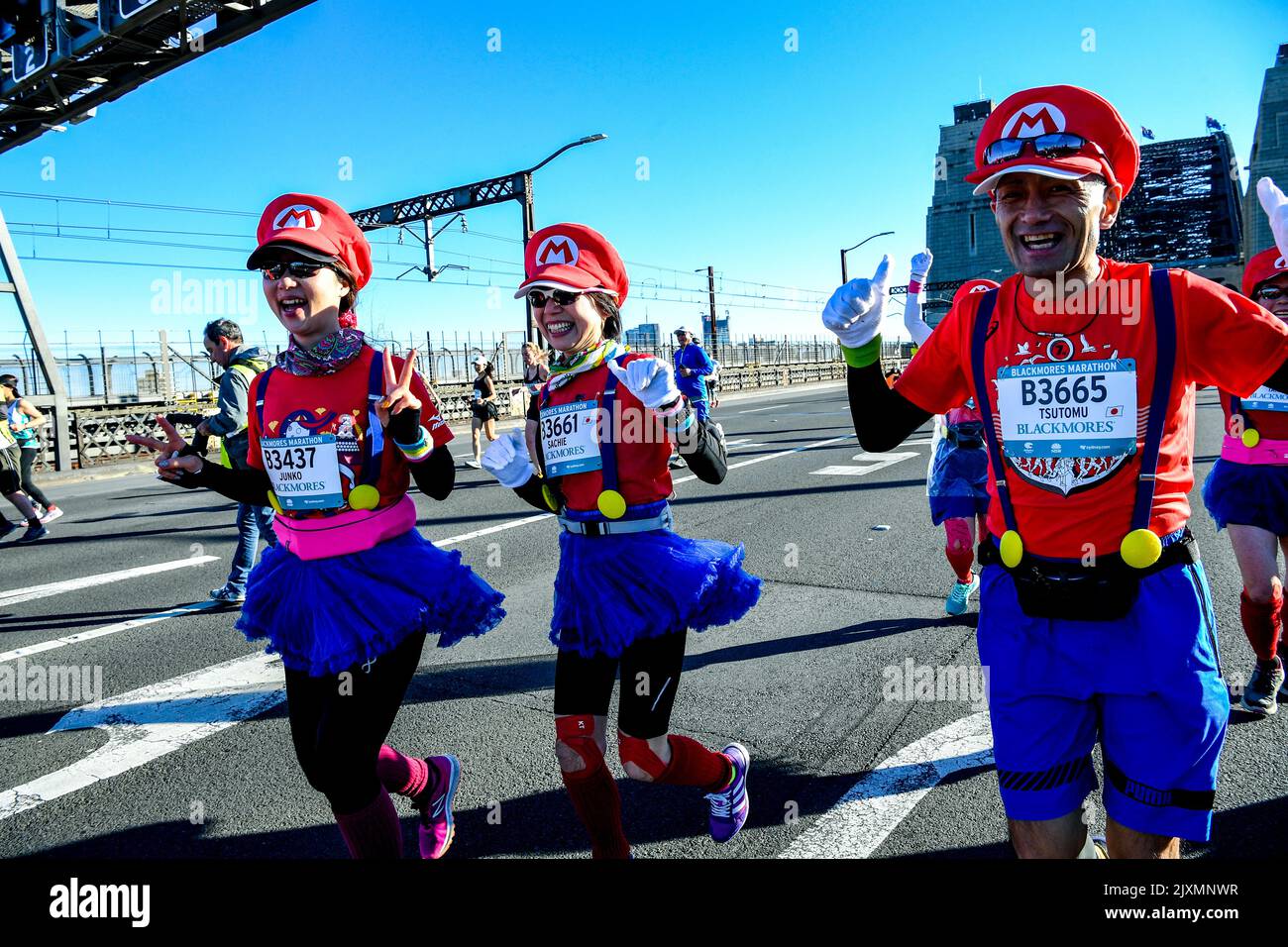 Runners are seen crossing the Sydney Harbour Bridge during the ...
