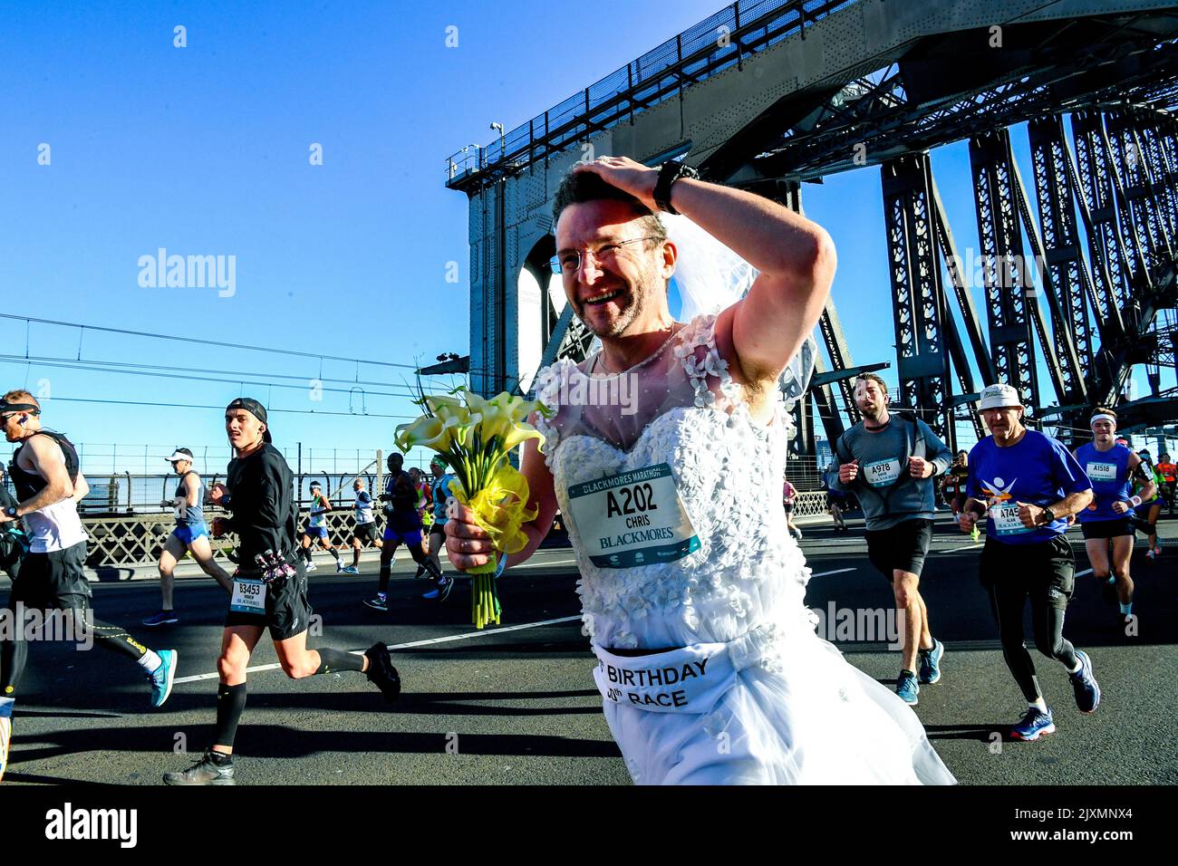 Runners are seen crossing the Sydney Harbour Bridge during the ...
